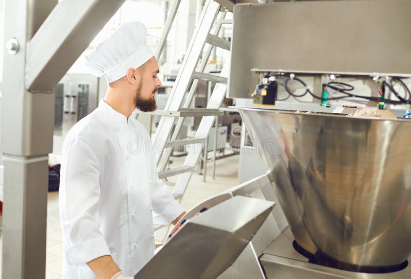 A Baker Controls the Process of Creating Dough for Baking Bread. Stock ...