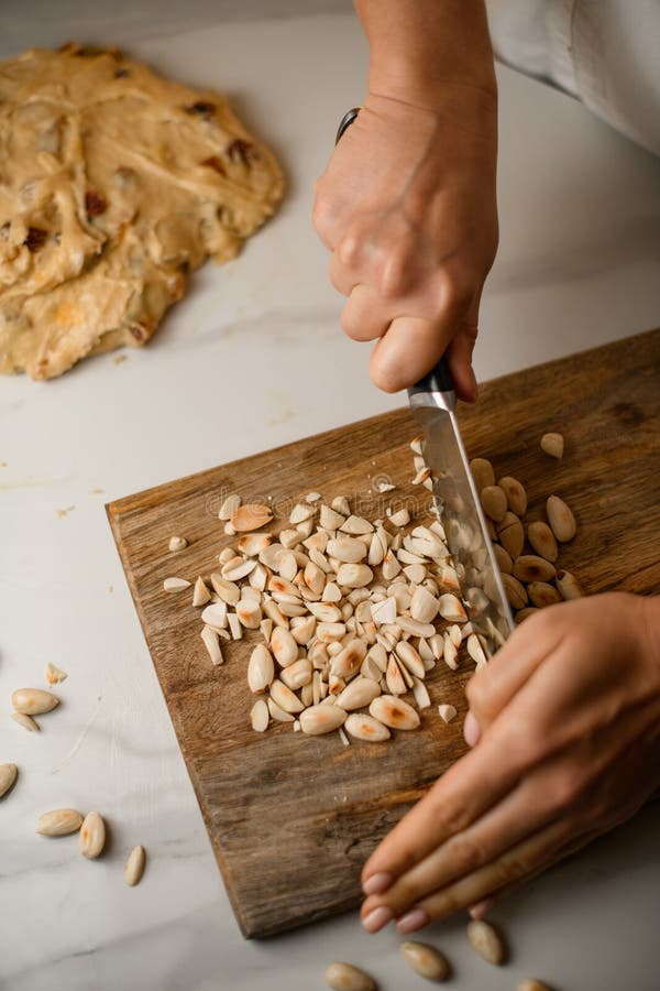 Baker Cuts Peanuts on a Cutting Board with a Knife Stock Photo - Image ...