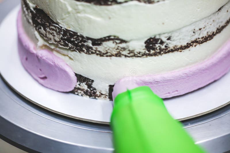 Baker Decorating a Beautiful Purple Cake in the Kitchen Stock Photo ...