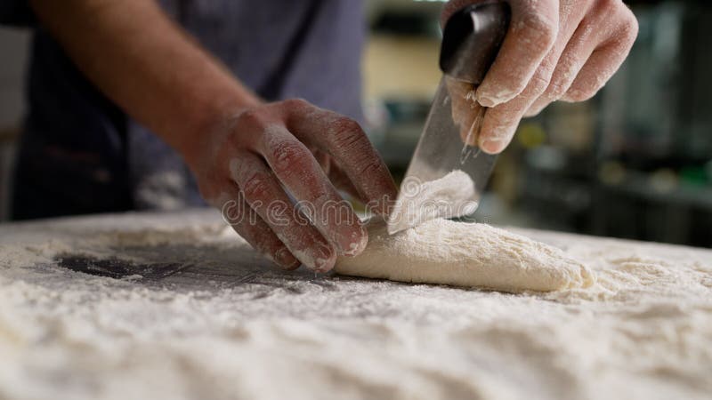 Baker Dividing Dough with Bench Scraper on Floured Surface. Stock Image ...