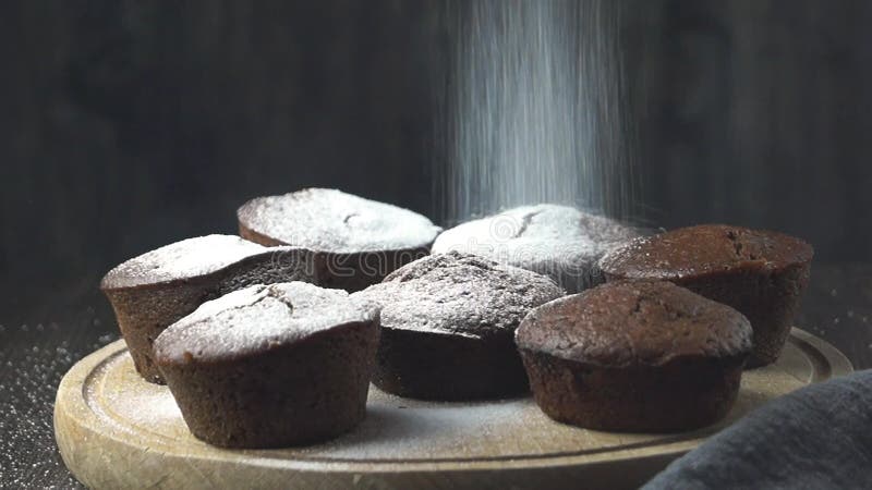 Baker Dusting Sugar Over Freshly Baked Cinnamon Rolls in a Cozy Kitchen ...
