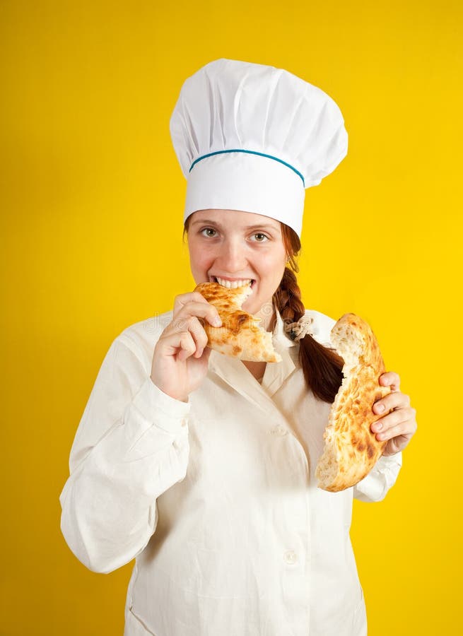 Baker is eating fresh loaf stock photo. Image of female - 18793892