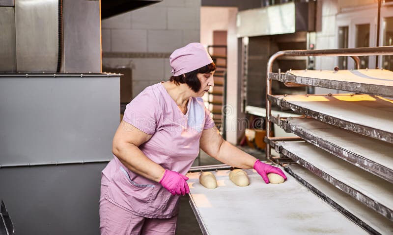 The Baker Forms the Dough for Baking Bread and Put it into Oven-tray at ...