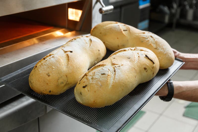 Baker Gets Hot Bread Out of the Oven Stock Photo - Image of lunch ...