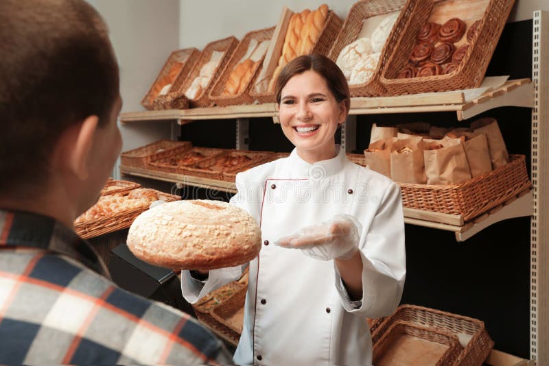 Baker Giving Customer Fresh Bread Stock Photo - Image of baker, people ...