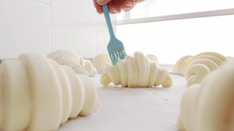 Baker Greases Freshly Baked French Croissants with Ghee at Bakery ...