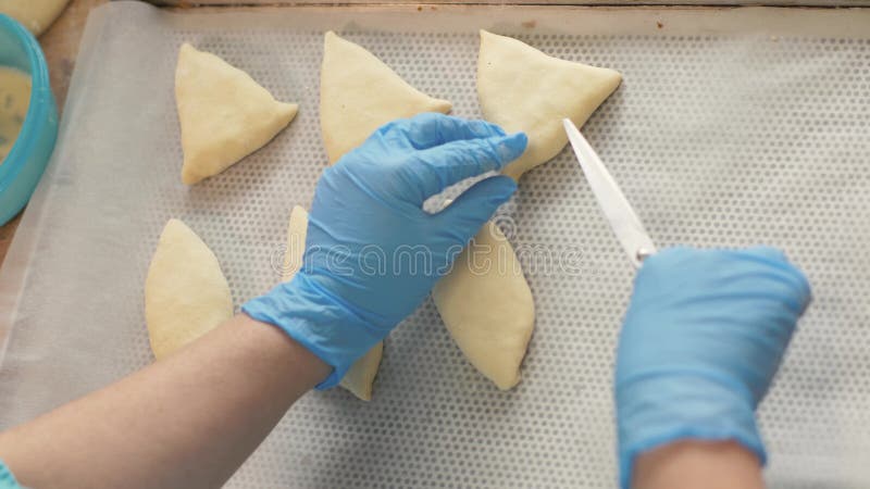 Baker Hand Cuts with Scissors and Inflicts Egg Mixture with Brush on ...