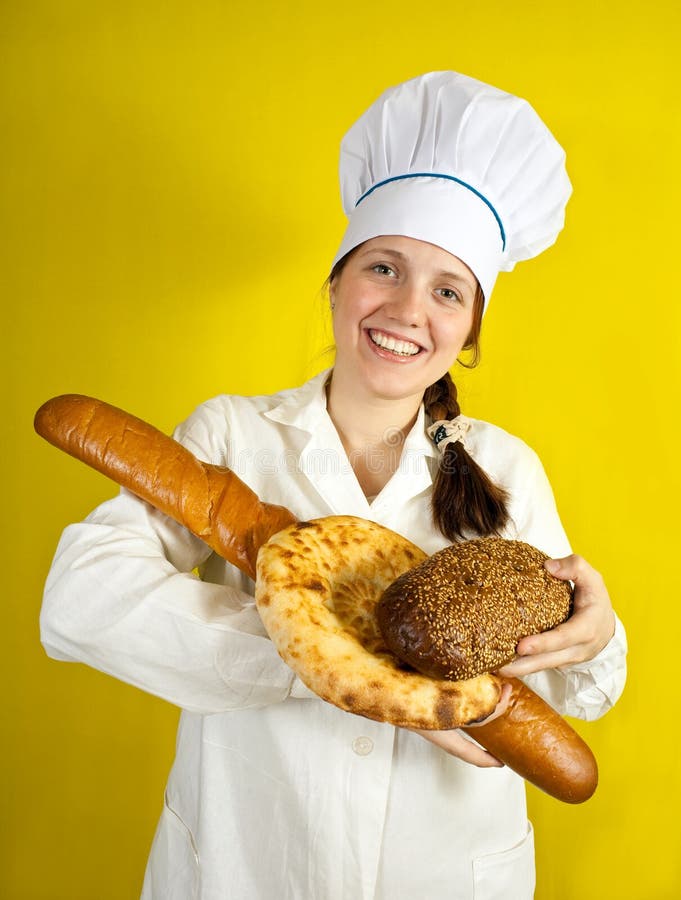 Baker is eating fresh loaf stock photo. Image of female - 18793892