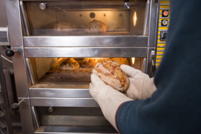 Baker is holding bread stock photo. Image of wood, kitchen - 254941110