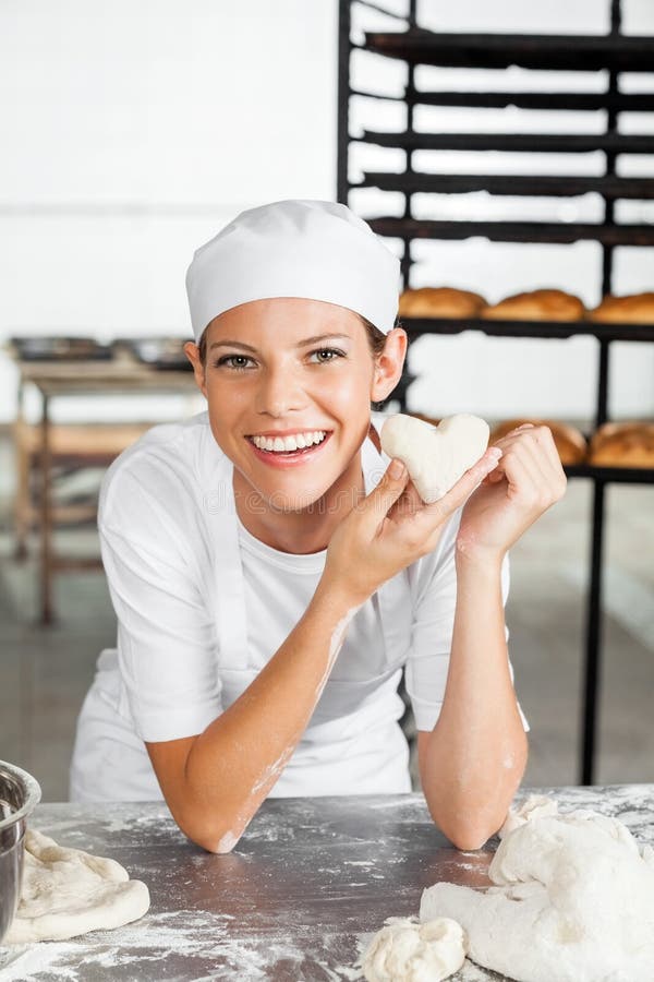 Baker Holding Heart Shape Dough while Leaning on Stock Photo - Image of ...