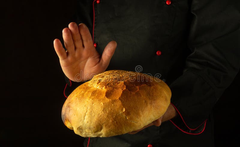 The Baker Holds Round Wheat Bread in His Hand. Serving Bread on the ...