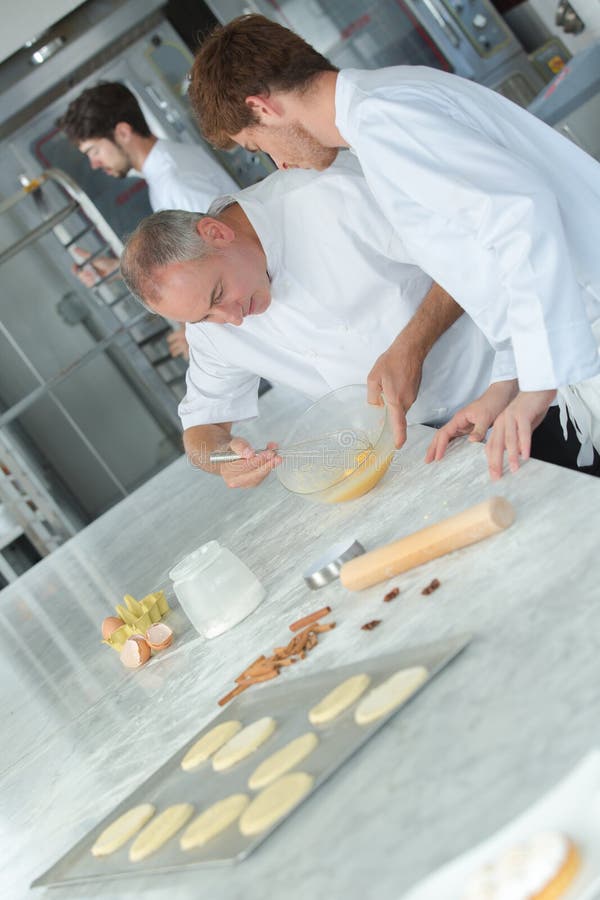 Baker Instructing Apprentice How To Knead Dough Properly Stock Image ...