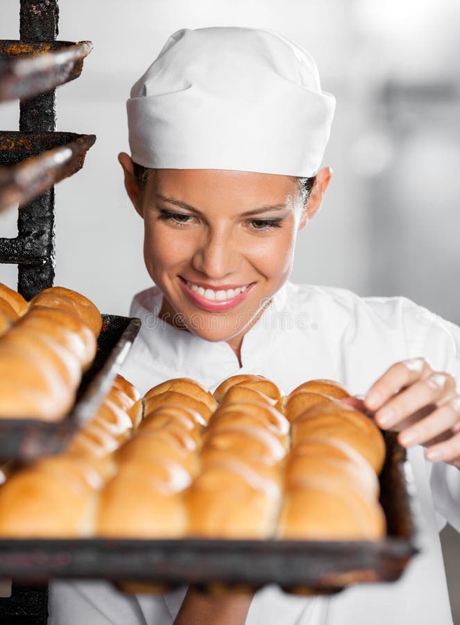 Baker Looking at Freshly Baked Breads in Bakery Stock Image - Image of ...