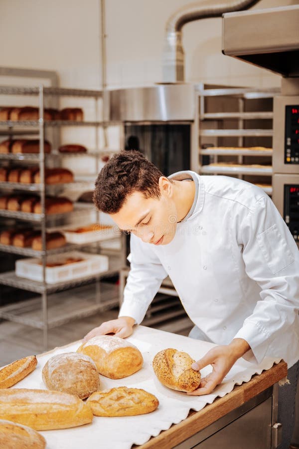 Baker Looking at the Tray and Checking the Readiness of Bread Stock ...