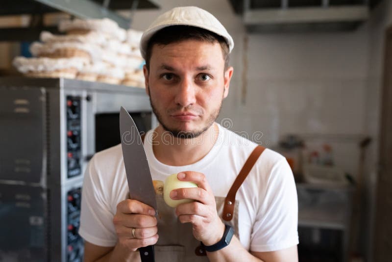 A Baker is Peeling Onions in a Small Artisan Bakery. Stock Photo ...