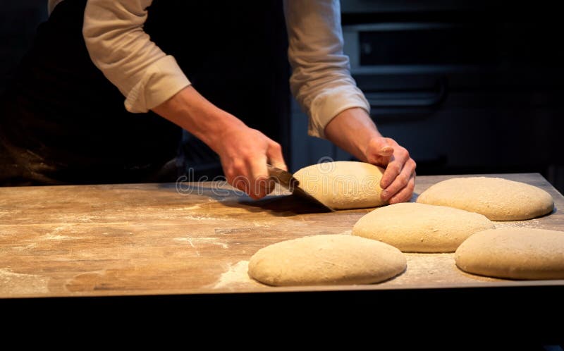 Baker Portioning Dough with Bench Cutter at Bakery Stock Photo - Image ...