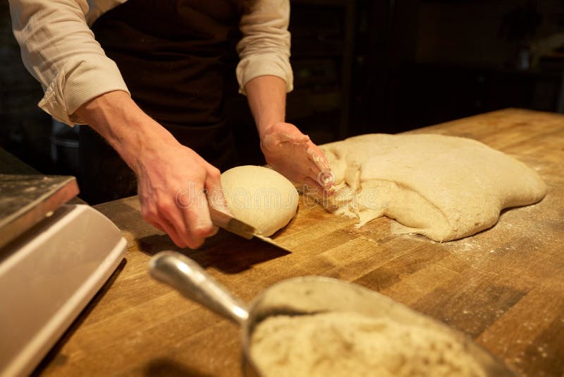 Baker Portioning Dough with Bench Cutter at Bakery Stock Image - Image ...