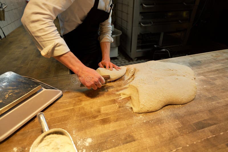 Baker Portioning Dough with Bench Cutter at Bakery Stock Image - Image ...