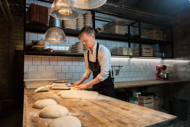 Baker Portioning Dough with Bench Cutter at Bakery Stock Image - Image ...