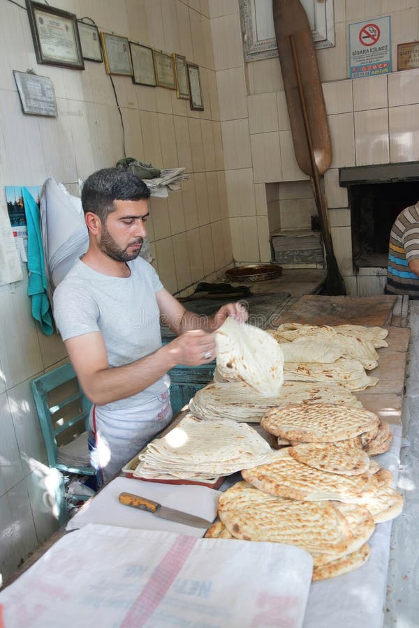 Baker prepares flatbread editorial image. Image of baker - 293604615