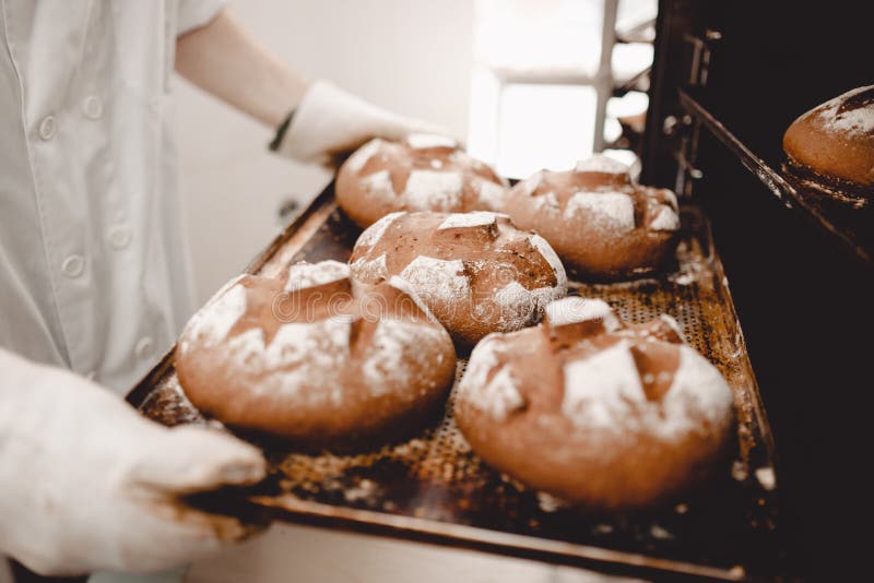 Baker Pulls Out of the Oven a Baking Sheet the Baking Tray with Newly ...