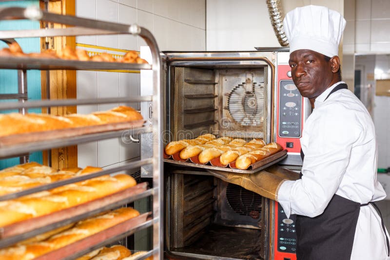 Baker Putting Baked Bread on Rack Stock Photo - Image of bakeshop ...