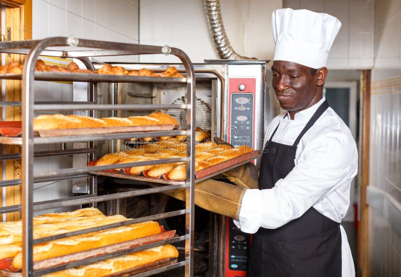 Baker Putting Baked Bread on Rack Stock Image - Image of chef, african ...