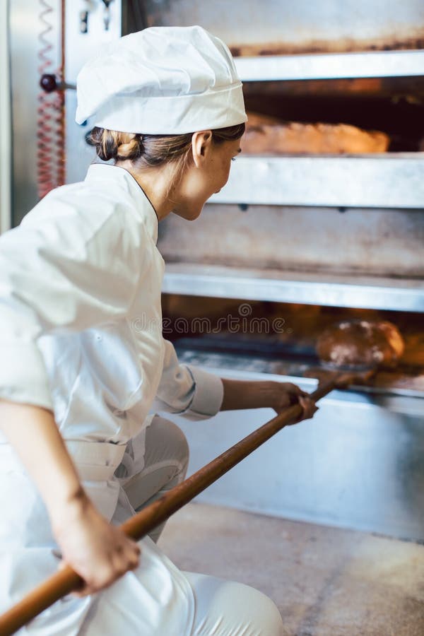Baker Putting Bread in the Bakery Oven Stock Photo - Image of ...