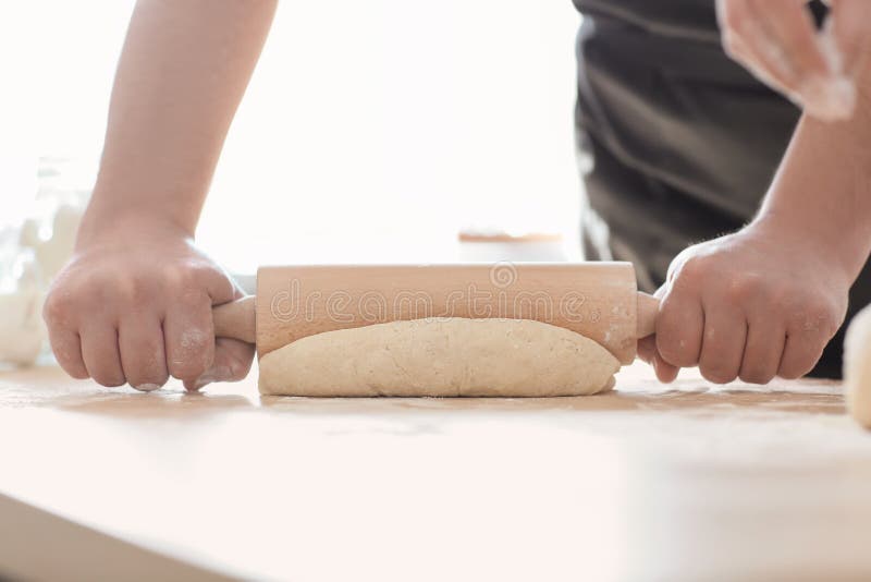 Baker is rolling a dough stock photo. Image of cooking - 65132770