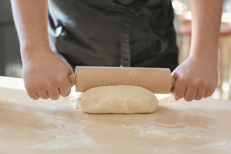 Baker is rolling a dough stock photo. Image of cooking - 65132770