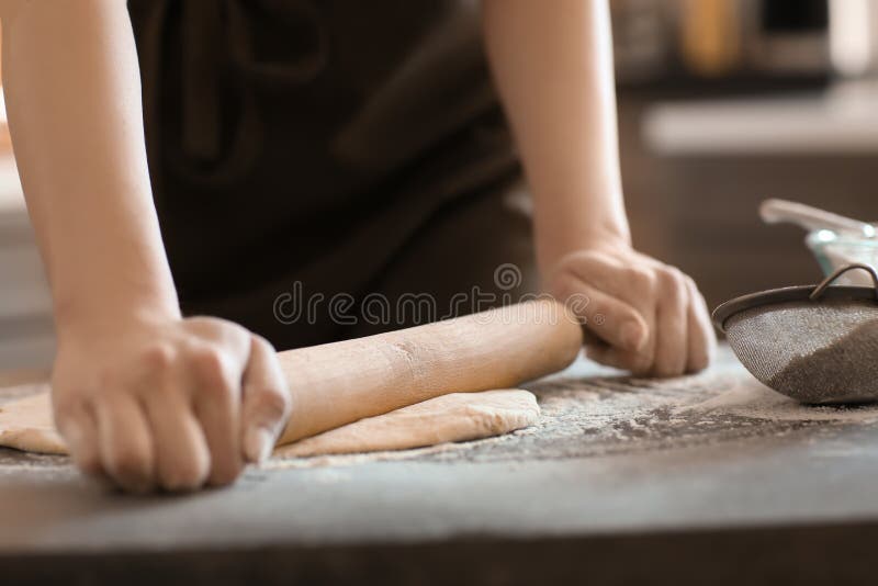 Baker is rolling a dough stock photo. Image of cooking - 65132770