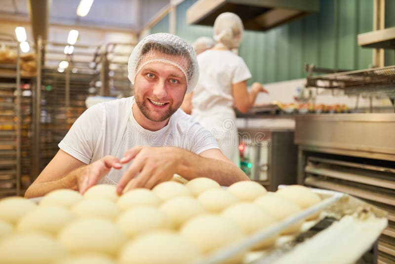 Baker`s Apprentice Baking Buns in a Large Bakery Stock Image - Image of ...