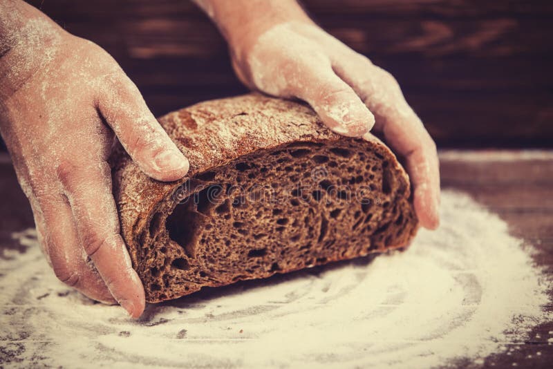 Baker S Hands with a Bread. Stock Photo - Image of giving, eating: 36952336