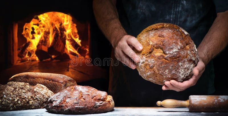 Baker`s Hands Holding and Presenting Fresh Baked Loaf of Bread Stock ...