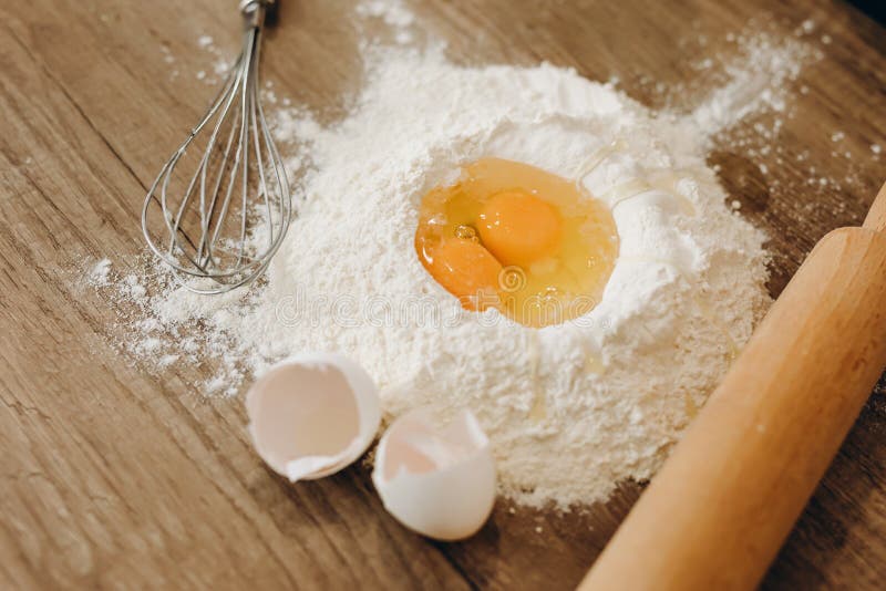 Baker S Hands with Plain Flour Well and Eggs in Preparation Process for ...