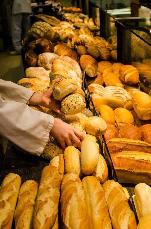 Hand of Baker or Apprentice Baker Taking Baguettes Out of Oven Stock ...