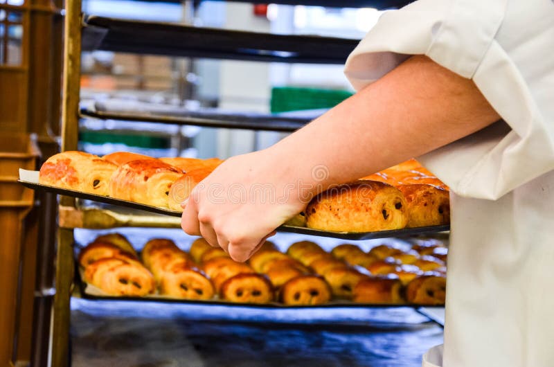 Hand of a Baker or Apprentice Baker Taking the Pain Au Chocolat or ...