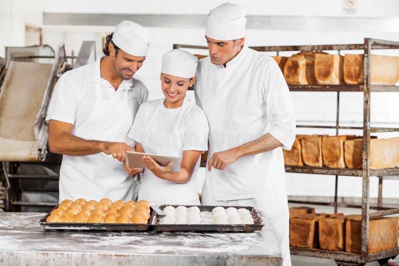 Baker S Using Tablet Computer Together in Bakery Stock Photo - Image of ...
