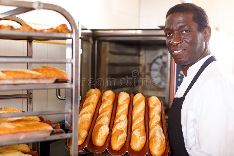 Baker Showing Tray of Fresh Bread Stock Photo - Image of african ...