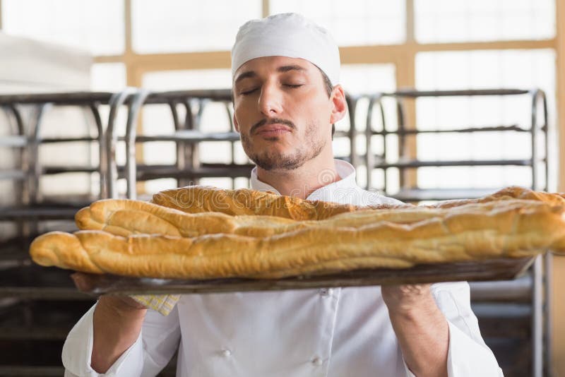 Baker Smelling Freshly Baked Baguettes Stock Image - Image of ...