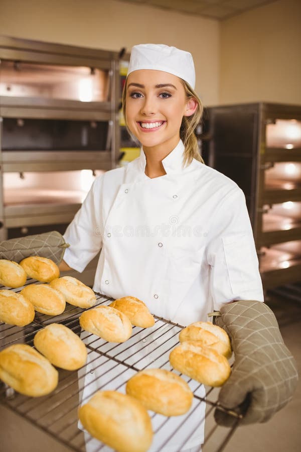 Baker Smiling at Camera Holding Rack of Rolls Stock Photo - Image of ...