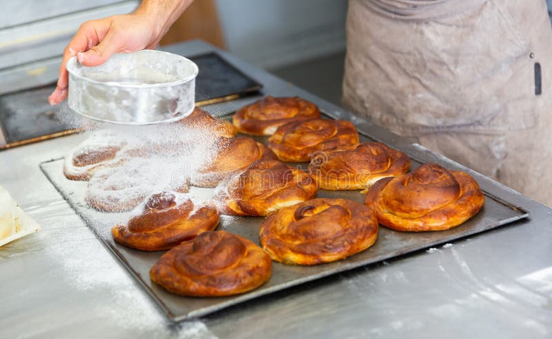 Baker Sprinkles Icing Sugar on Buns at Bakery Stock Image - Image of ...
