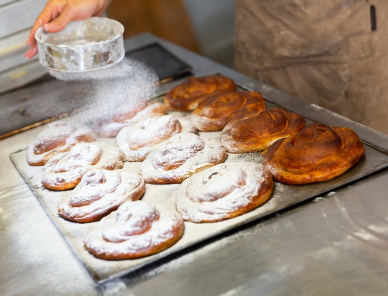 Baker Sprinkles Icing Sugar on Buns at Bakery Stock Image - Image of ...