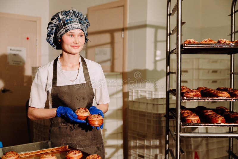 Baker Standing in His Bakery in the Morning and is Baking Bread or Buns ...