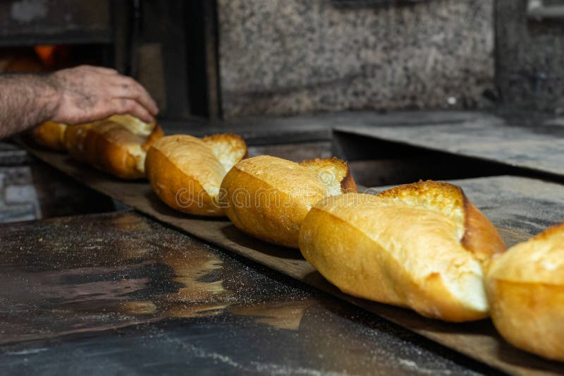 The Baker Takes the Baked Bread Out of the Oven. Turkish Bread ...