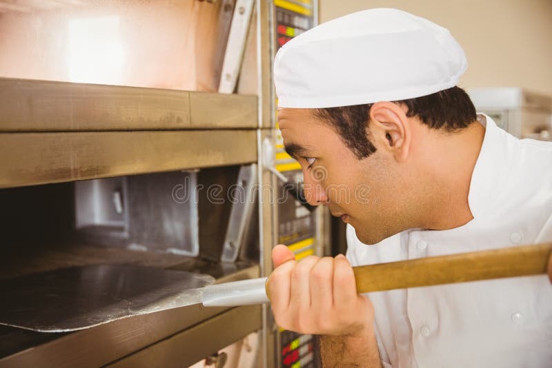 Baker Taking Bread Out of Oven Stock Photo - Image of side, hotel: 48988136