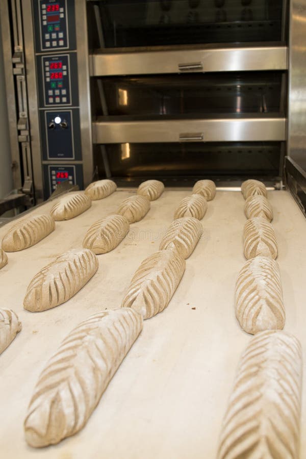Baker Taking Fresh Baked Bread from Oven. Manufacturing Process Stock ...