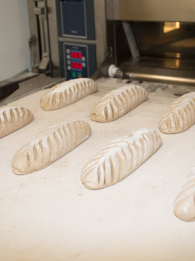 Baker Taking Fresh Baked Bread from Oven. Manufacturing Process Stock ...