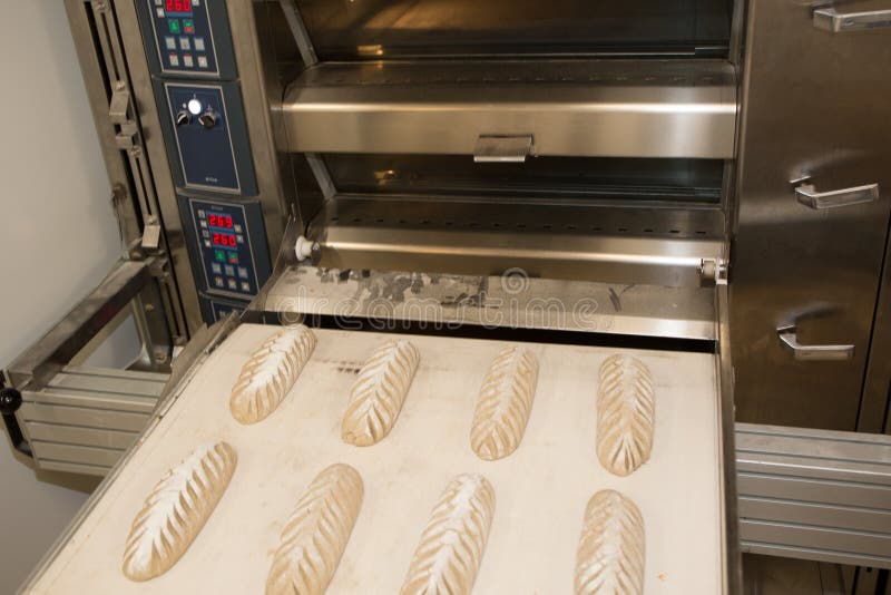 Baker Taking Fresh Baked Bread from Oven. Manufacturing Process Stock ...