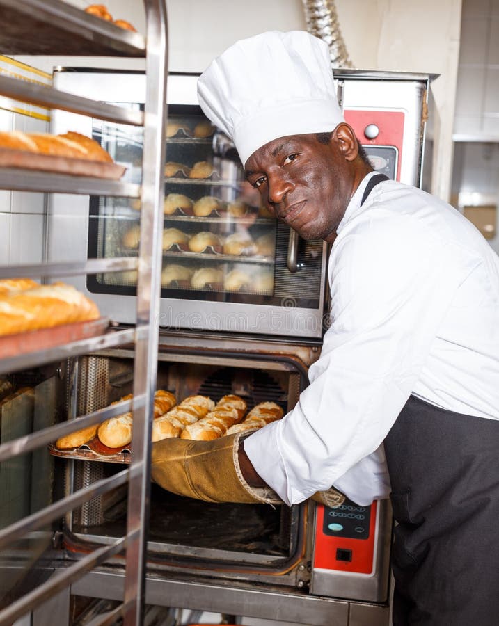 Baker Taking Out Bread from Oven Stock Photo - Image of bread ...